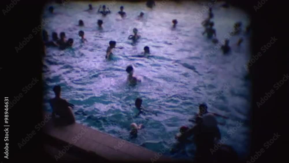 Vintage 8mm footage of a crowded pool with children and kids jumping ...