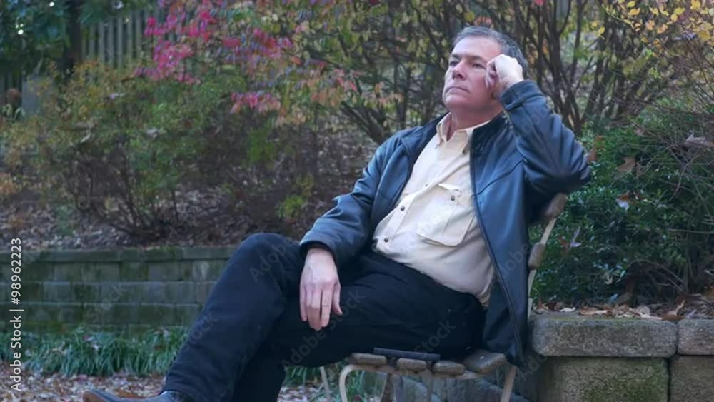 man sitting alone on a park bench thinking Stock Video | Adobe Stock