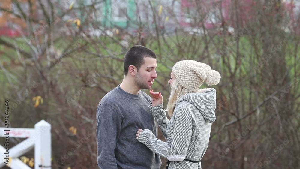 Young attractive couple in love, teenagers having fun outdoors, kissing ...