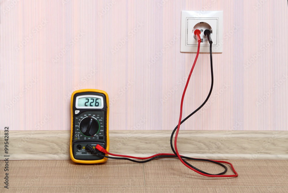 Metering socket voltage with digital multimeter. Stock Photo | Adobe Stock