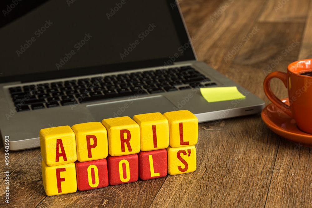 April Fools' written on a wooden cube in a office desk Stock Photo ...