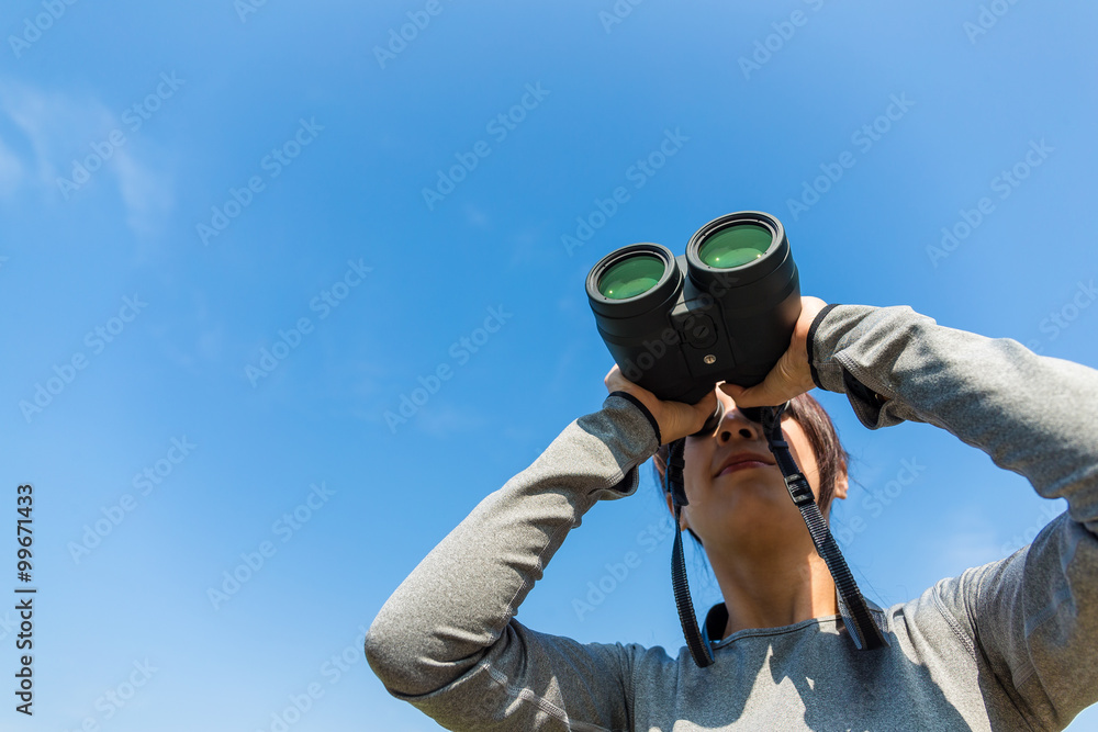 Woman use the binoculars with clear blue sky Stock Photo | Adobe Stock