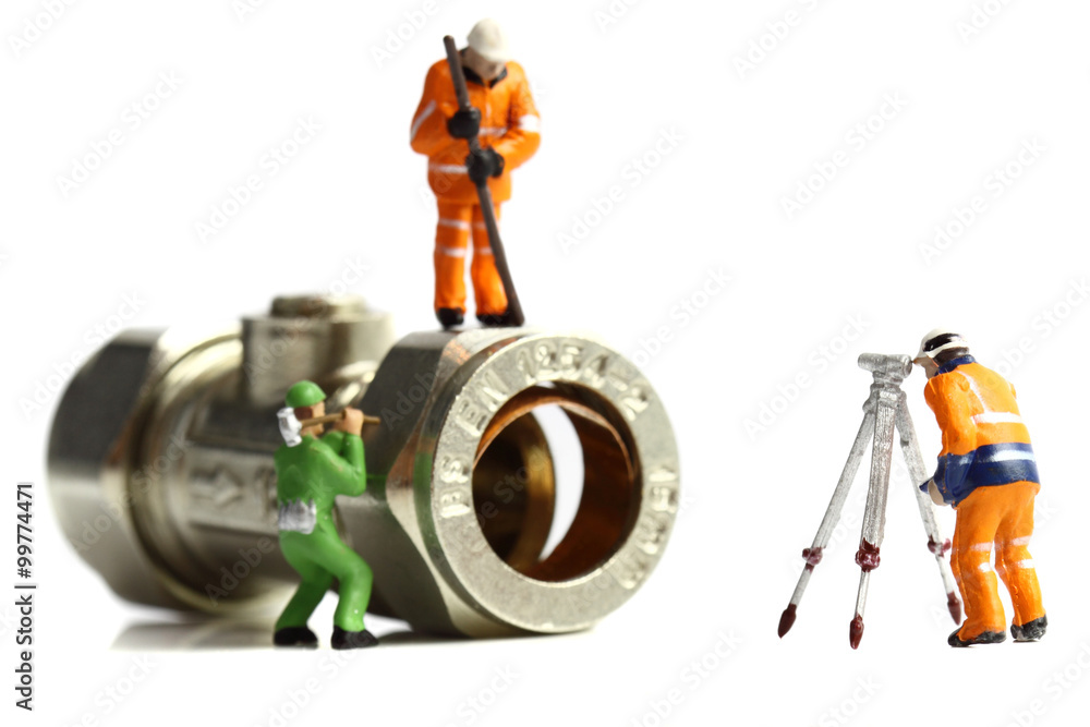 Miniature construction workers plumbing valve / Isolated miniature ...