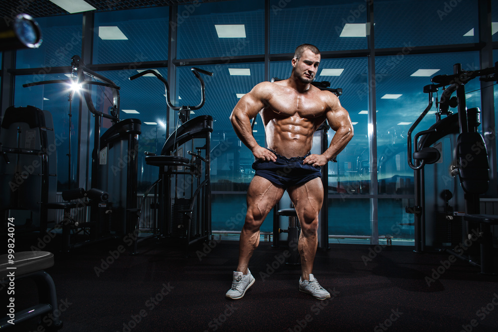 Strong Athletic Man Fitness Model Torso showing muscles in gym Stock ...