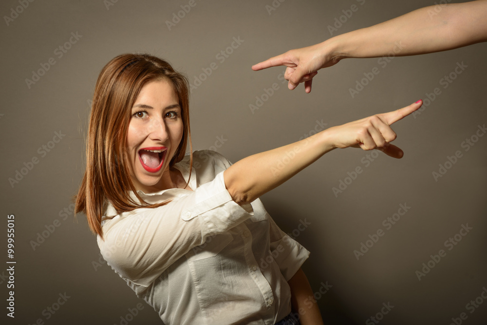 Move from one fault to another. Amused woman pointed finger on someone ...