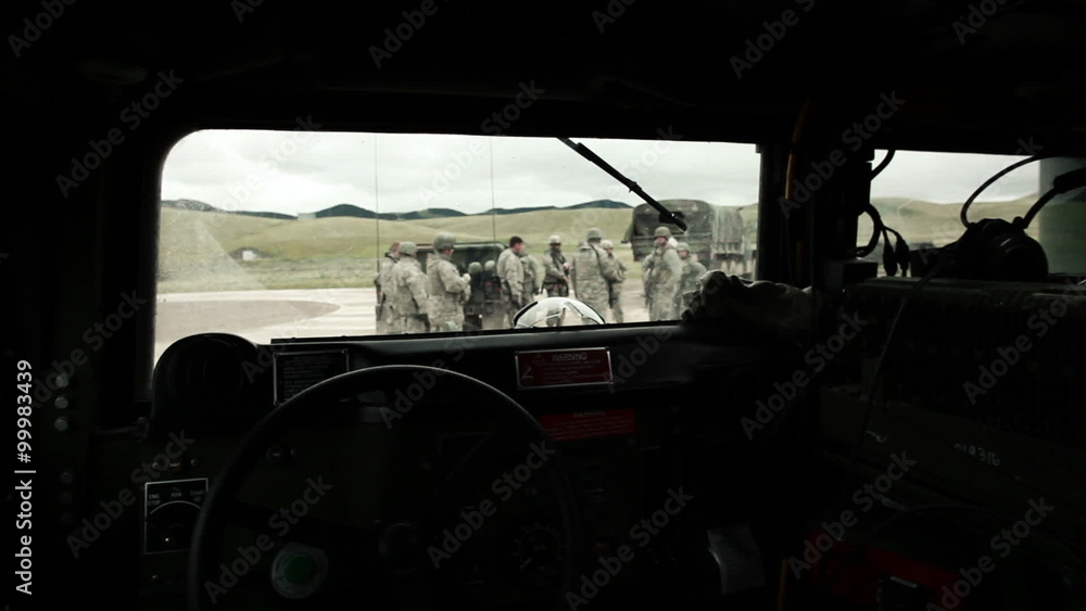 Shot from inside of Humvee of soldiers outside. Stock ビデオ | Adobe Stock
