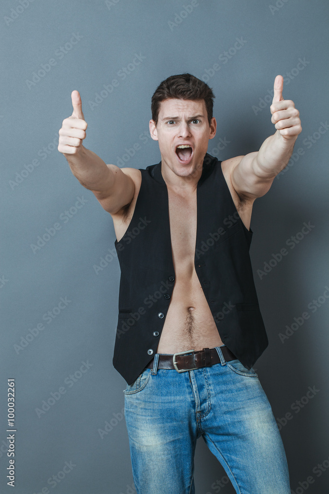 optimism concept - thrilled 20s sportsman with bare chest and thumbs up ...