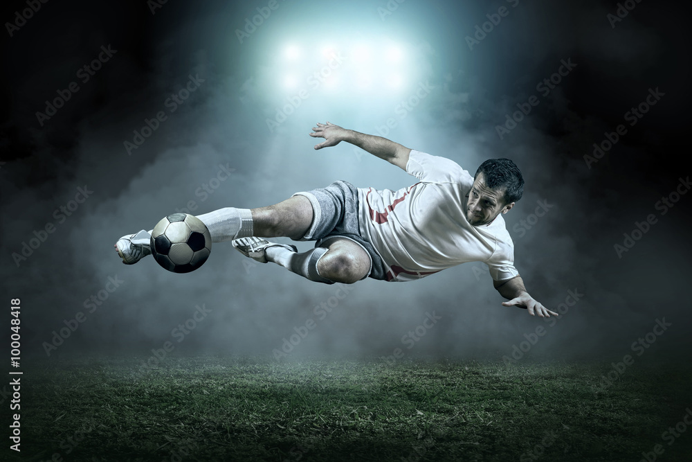 Soccer player with ball in action outdoors Stock Photo | Adobe Stock