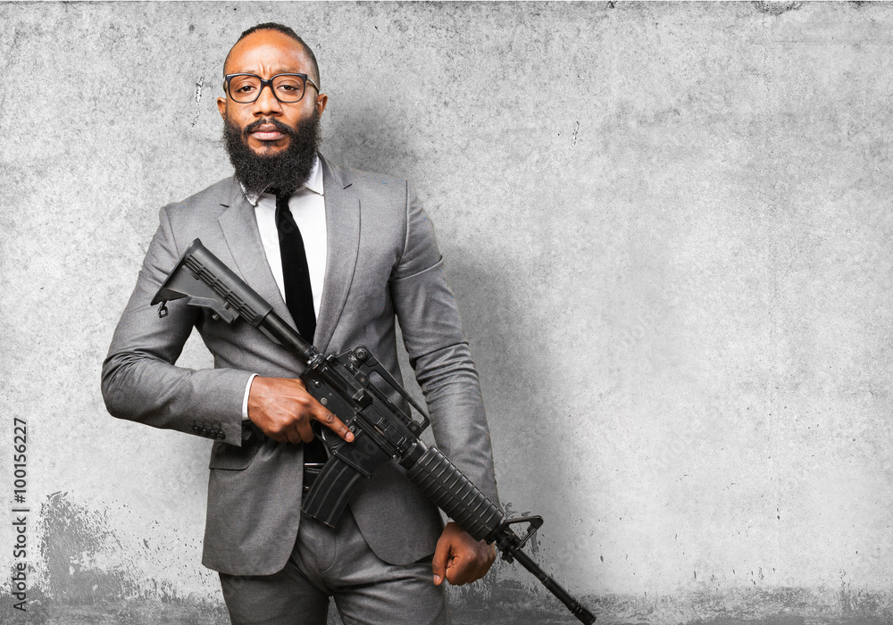 business black man holding a machine gun Stock Photo | Adobe Stock
