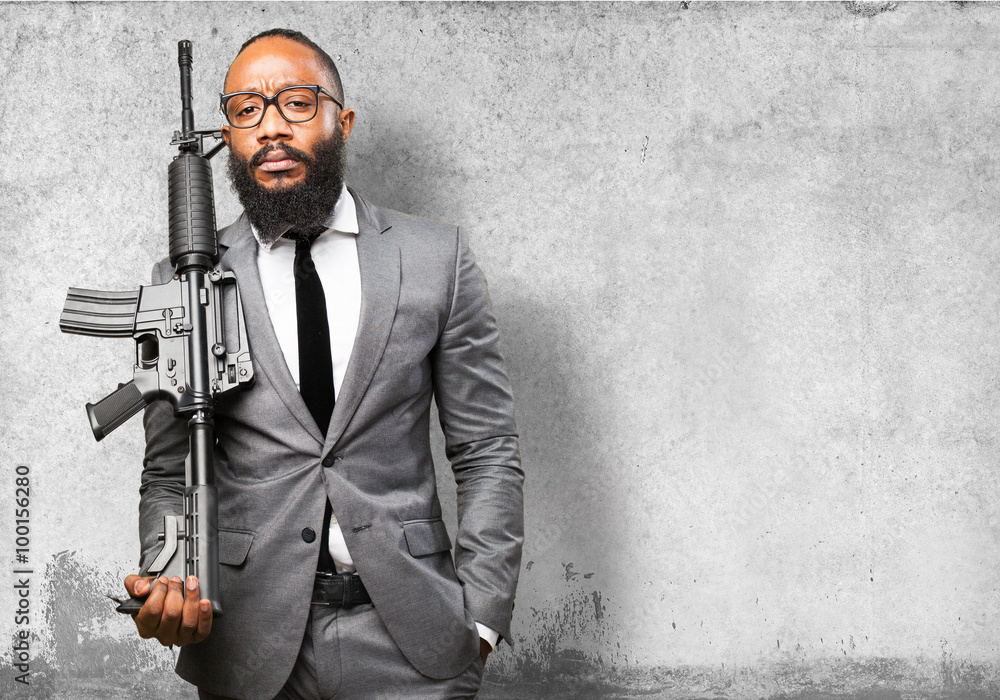 business black man holding a machine gun Stock Photo | Adobe Stock