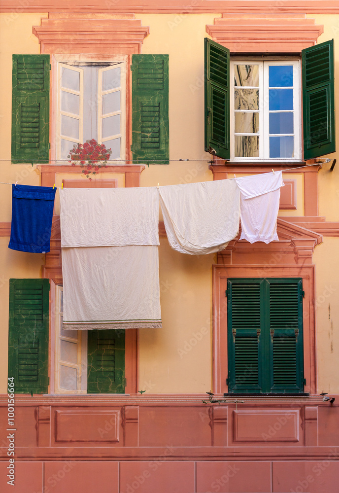 Shutters, fake windows and clothes hanging on a mediterranean fa Stock ...