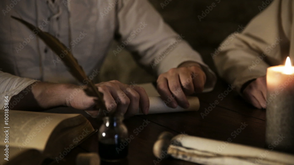 medieval business man is rolling a parchment, vintage look, office desk ...