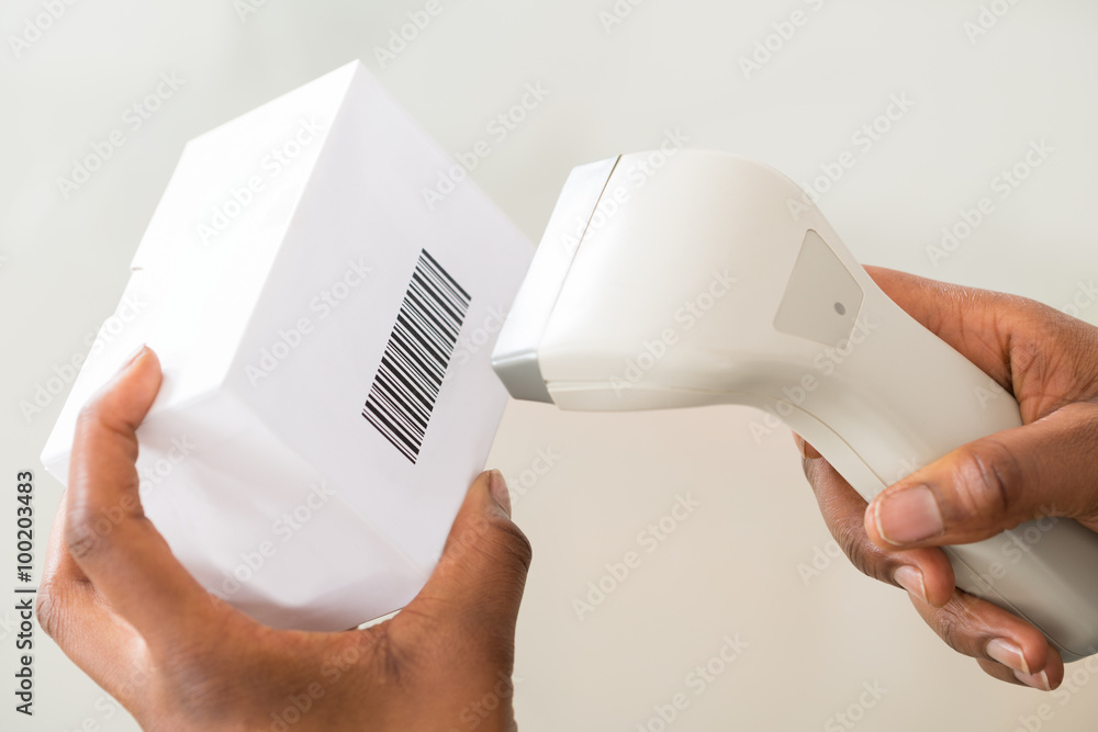 Person's Hand Using Barcode Scanner To Scan A Barcode Stock Photo ...
