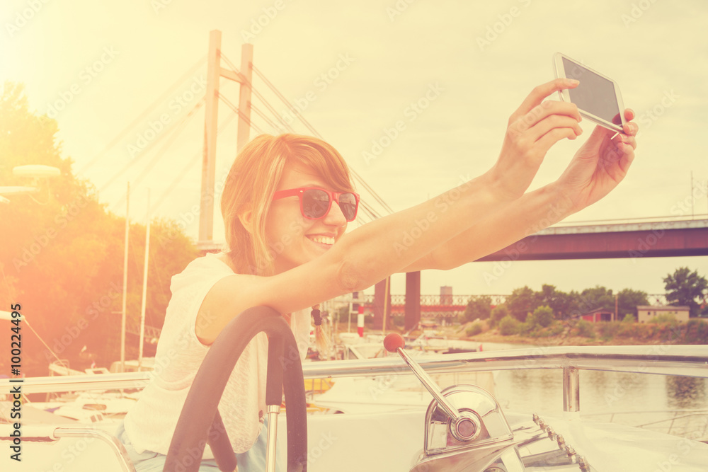 Girl doing selfie on a speedboat. Stock Photo | Adobe Stock