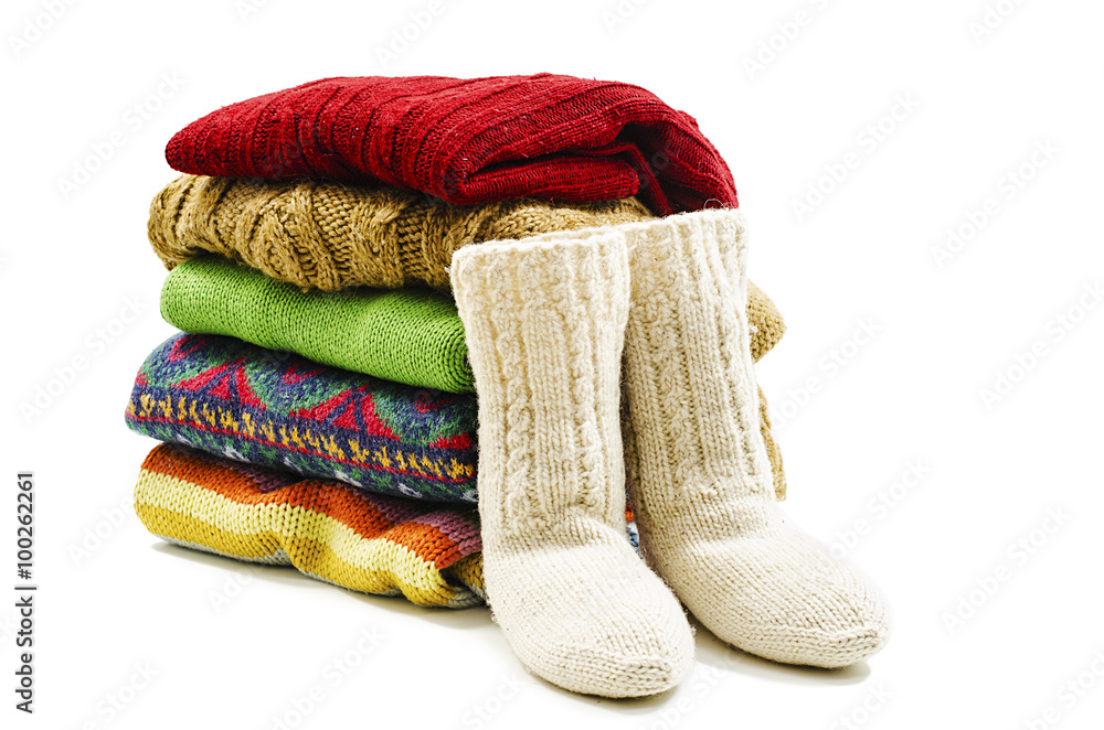 Wool socks and stack of various sweaters. Winter style. Isolated on ...