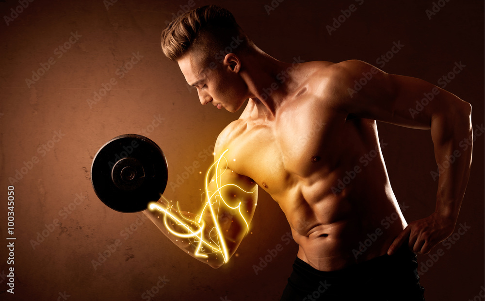 Muscular body builder lifting weight with energy lights on bicep Stock ...