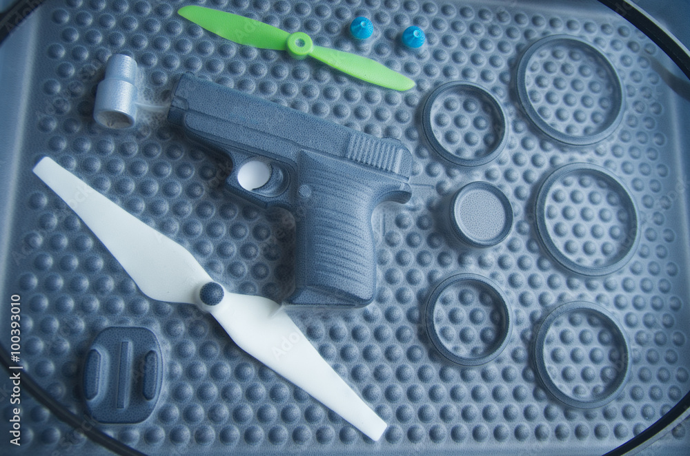 Black rubber rings, toy gun and small propellers lying on plastic ...