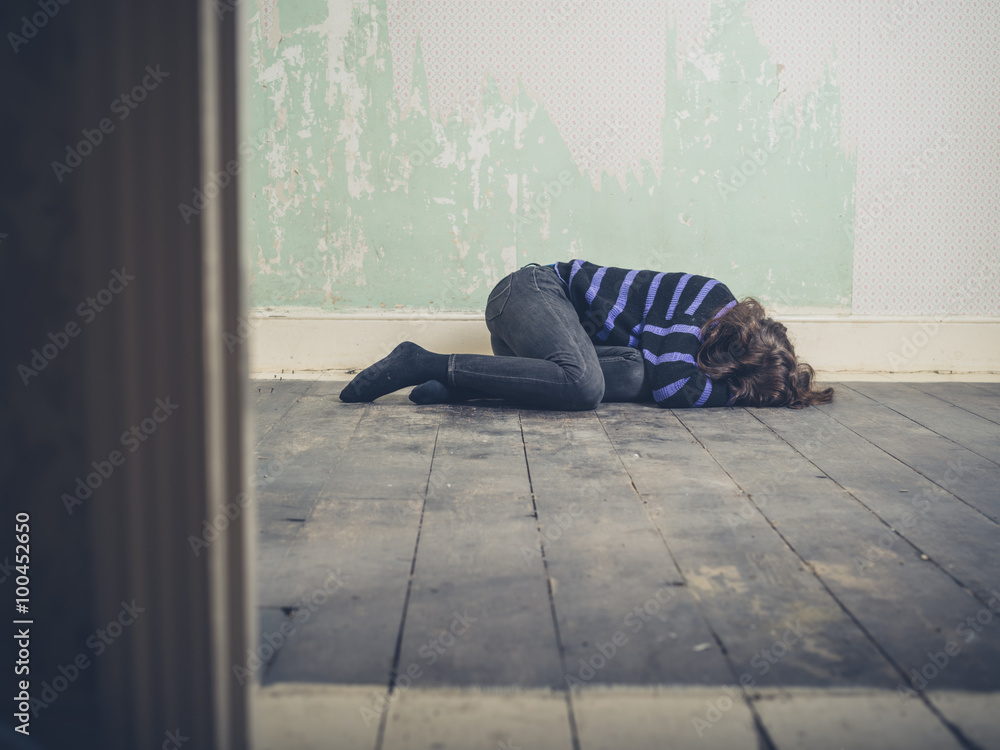 Sad young woman lying on floor Stock Photo | Adobe Stock