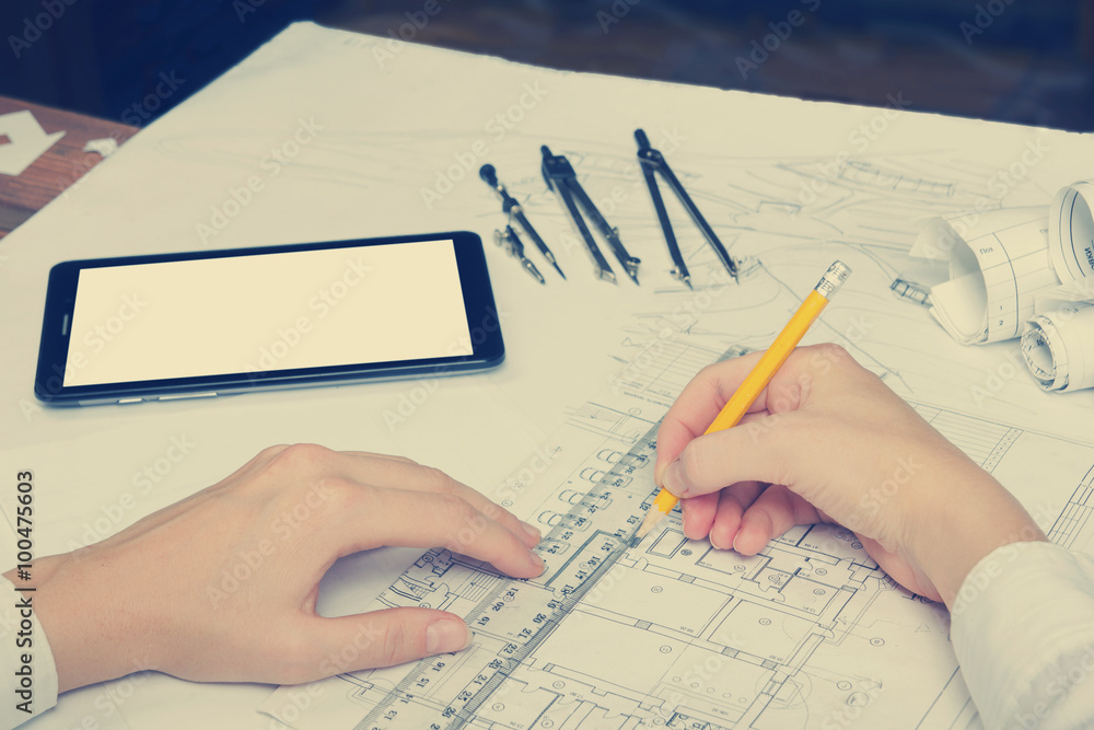 Architect working on blueprint. Architects workplace - architectural ...