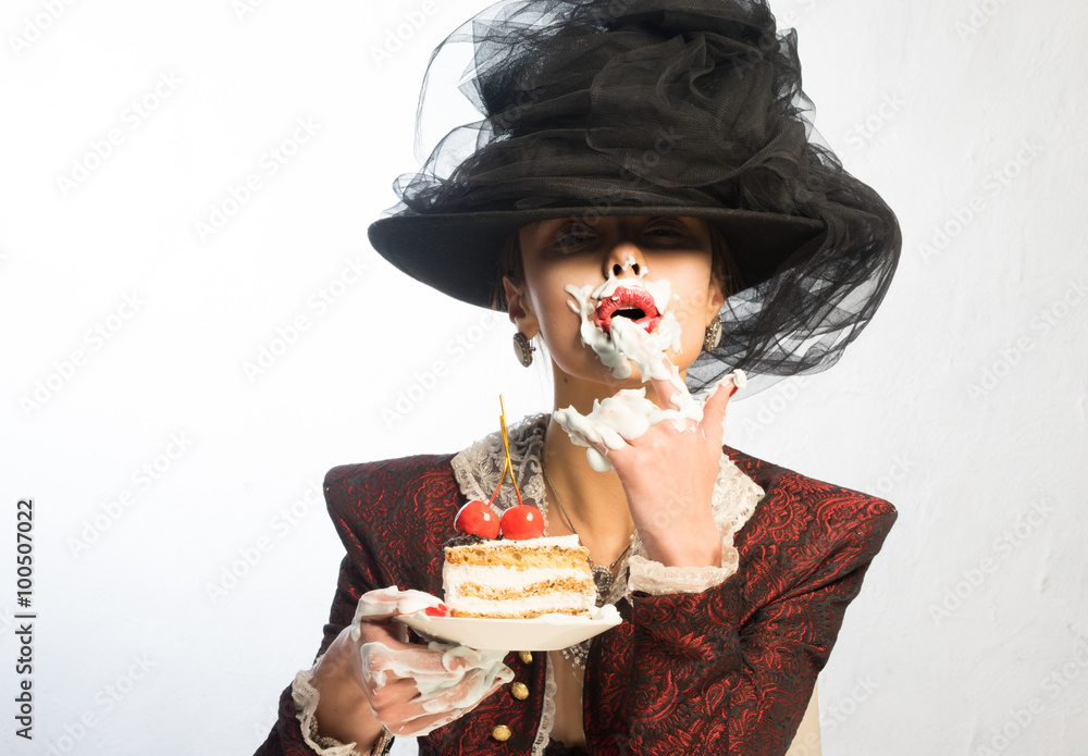 The girl in the hat messy eating cake with cherries Stock Photo | Adobe ...