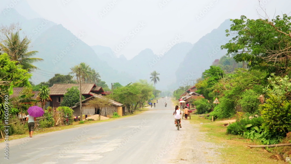 Daily life of Vang Vieng village with limestone mountains, Laos Stock ...