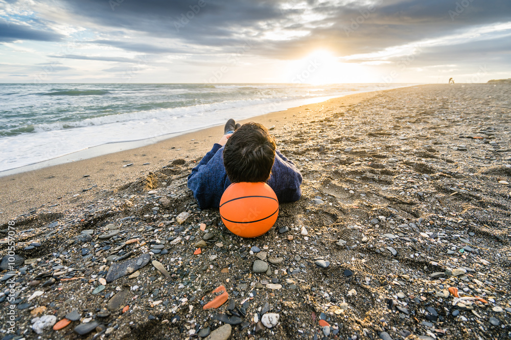 Man lying on the beach in the evening Stock Photo | Adobe Stock