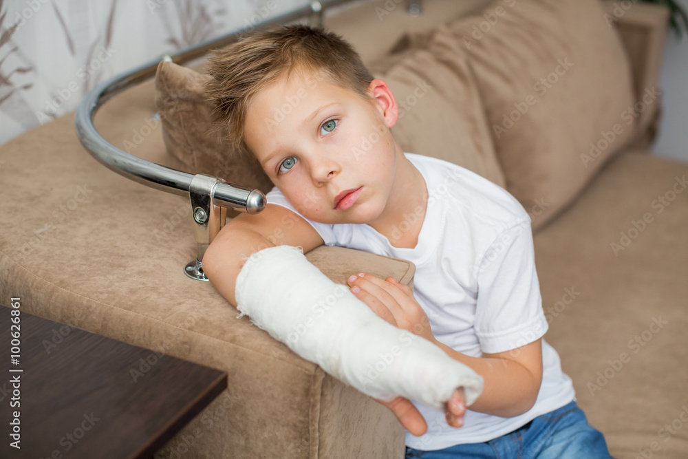 little boy with a broken arm. child in a cast. funny kid after accident ...