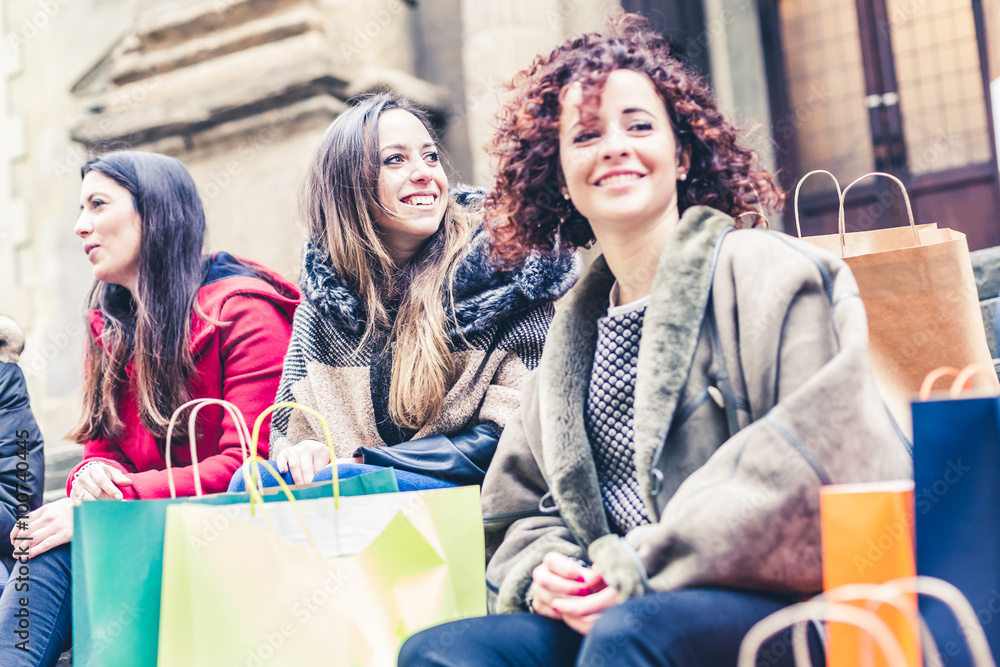 Three friends after shopping in around the city are resting on the ...