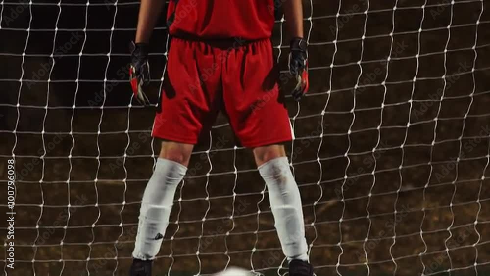 Pan down of a soccer goalkeeper right before a penalty kick is made ...