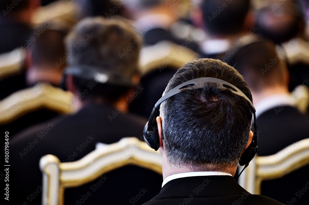People using headphones during conference Stock Photo | Adobe Stock