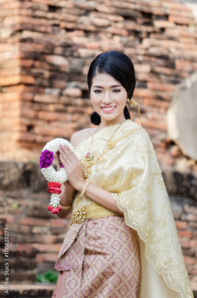 Woman wearing typical thai dress with thai style temple background ...