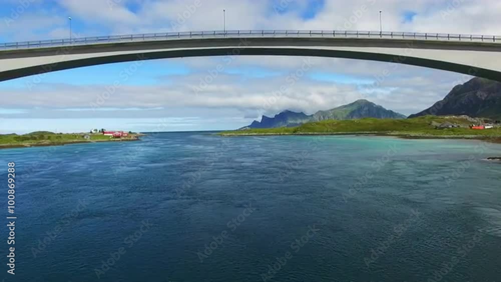 Flying under scenic bridge connecting two islands on Lofoten, Norway ...