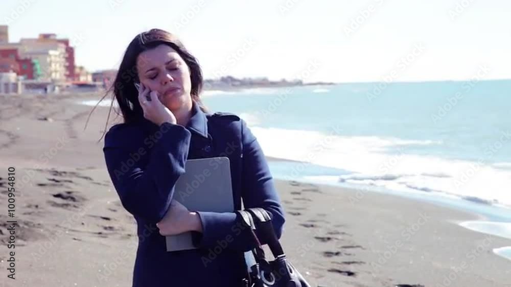 Sad angry woman talking on the phone walking on the beach Stock Video ...