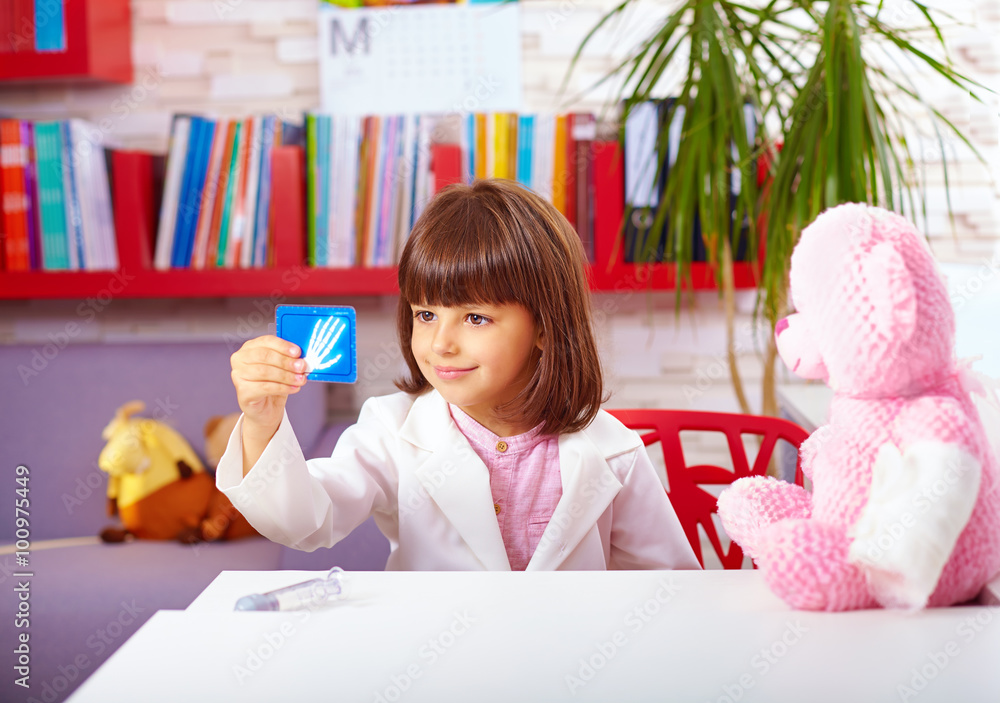 cute young kid playing a doctor in office Stock Photo | Adobe Stock
