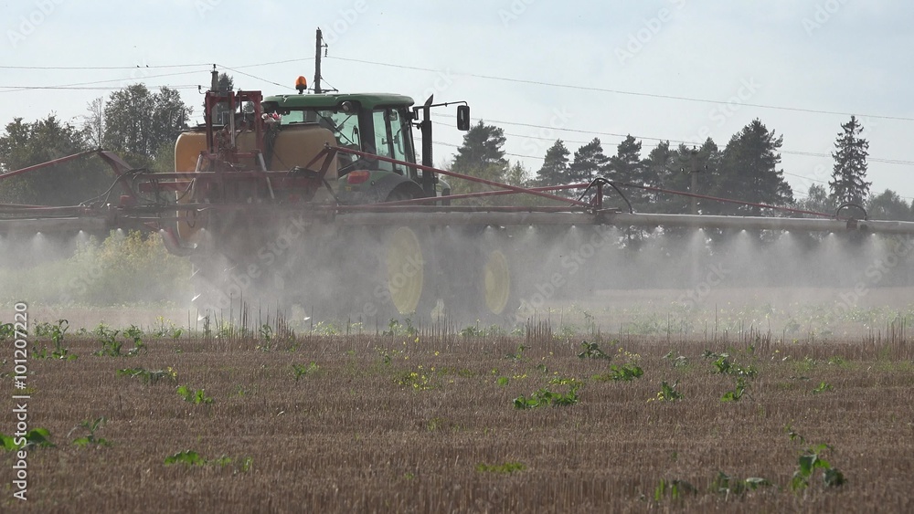 Back of vehicle spreading fertilizer on a farm field of corn stubble ...