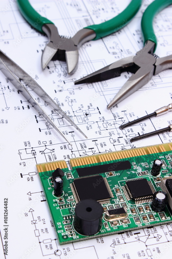 Printed circuit board and precision tools on diagram of electronics ...