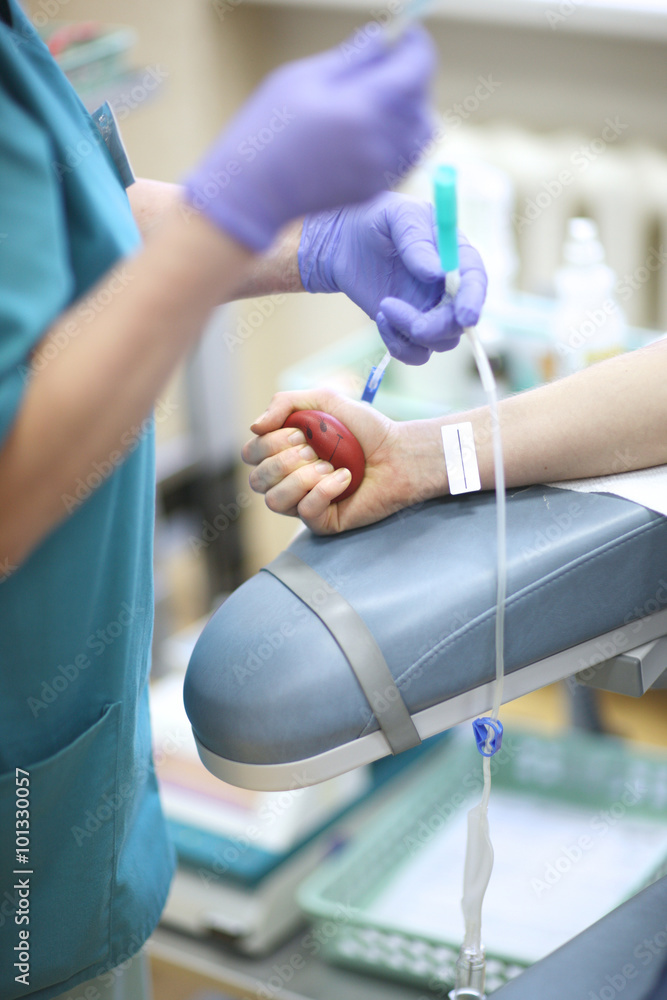 Blood transfusion, hands of donor and doctor preparing for an injection ...