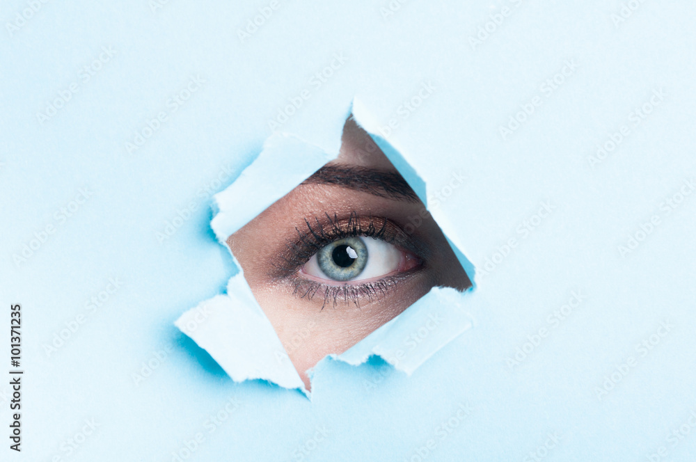 Female eye with mascara looking thru torn cardboard Stock Photo | Adobe ...