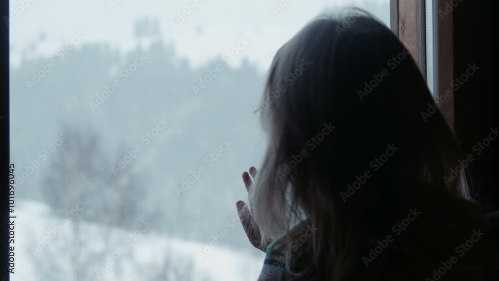 Little cute girl behind window in winter Stock Video | Adobe Stock