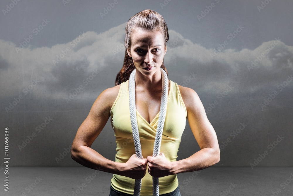Composite image of portrait of healthy woman holding rope Stock Photo ...