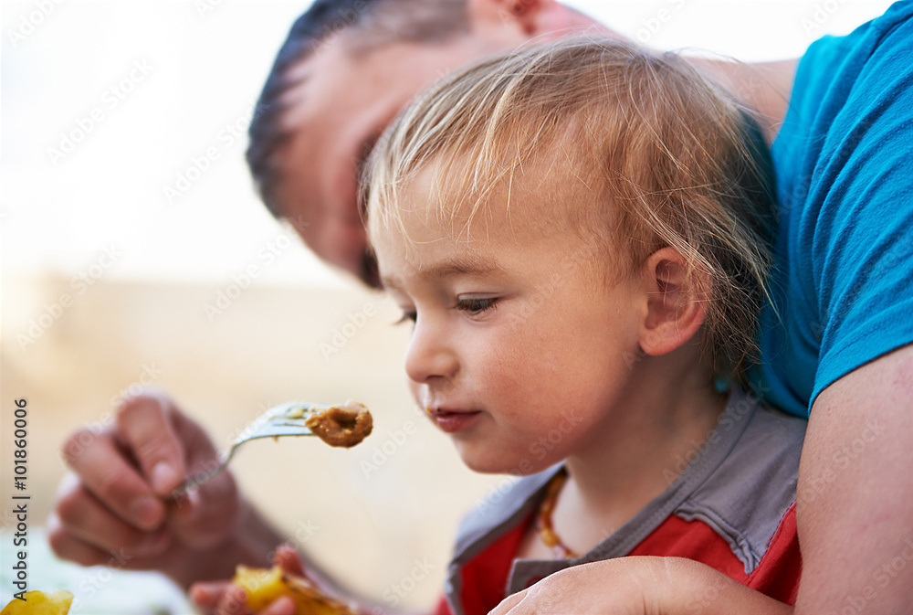 Young father feeding his child son little boy at the table Stock Photo ...