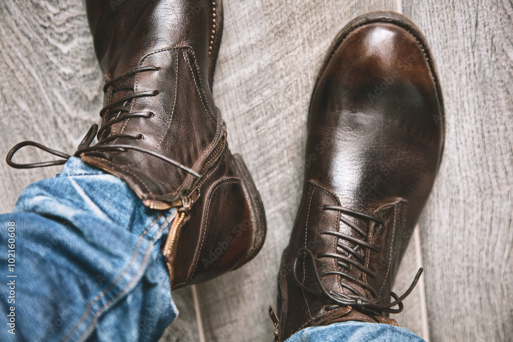 boots and jeans in motion. Young fashion man's legs in jeans and boots ...