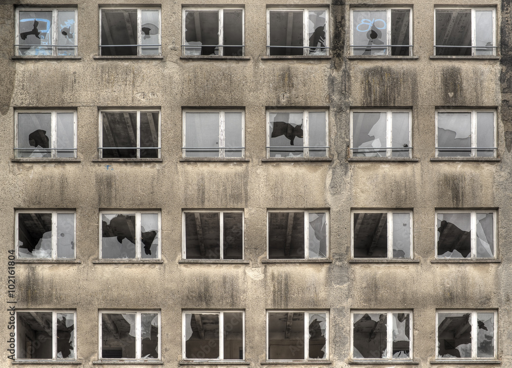 facade with broken windows of a historical abandoned building from nazi ...