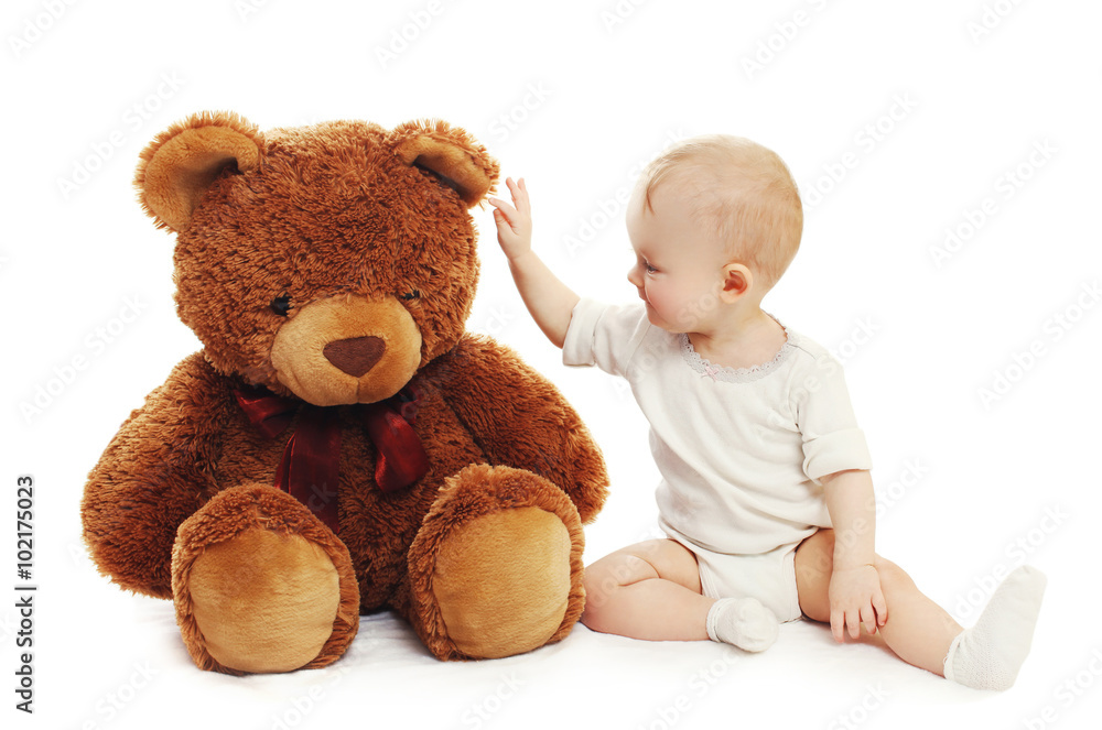 Cute baby playing with big teddy bear on white background Stock Photo ...