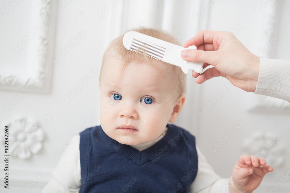 Beautiful baby boy with mother combing Stock-Foto | Adobe Stock