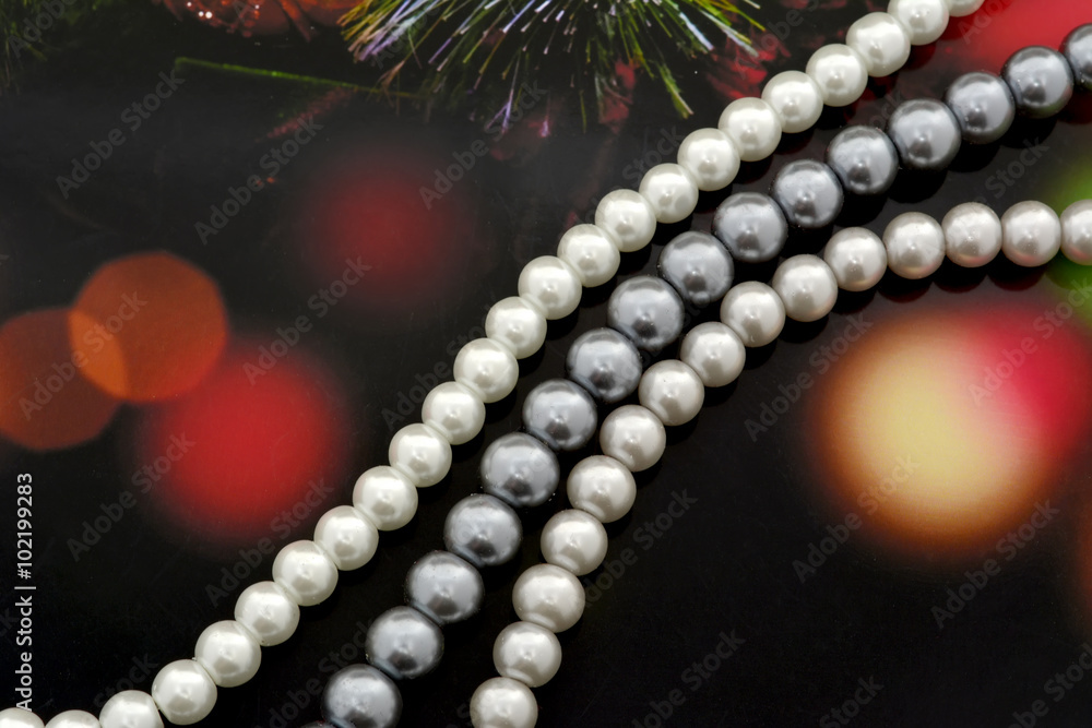 Strings of pearl beads on dark background Stock Photo | Adobe Stock