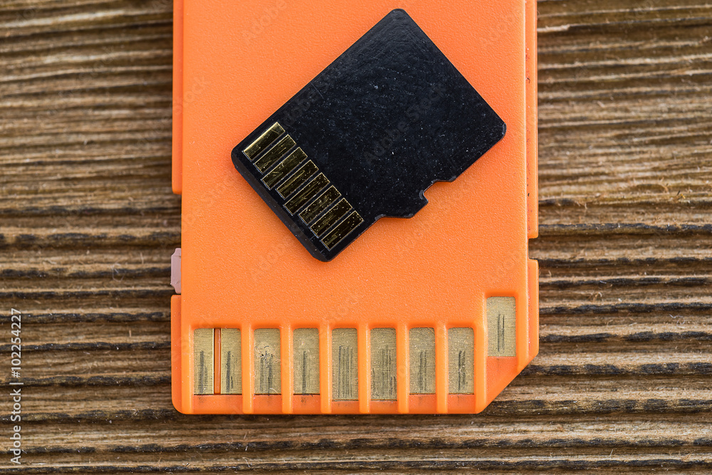 Orange memory SD card, old wood background Stock Photo | Adobe Stock