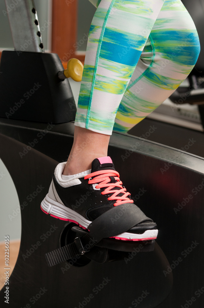 Young female feet exercising and pedaling the stationary bicycle Stock ...