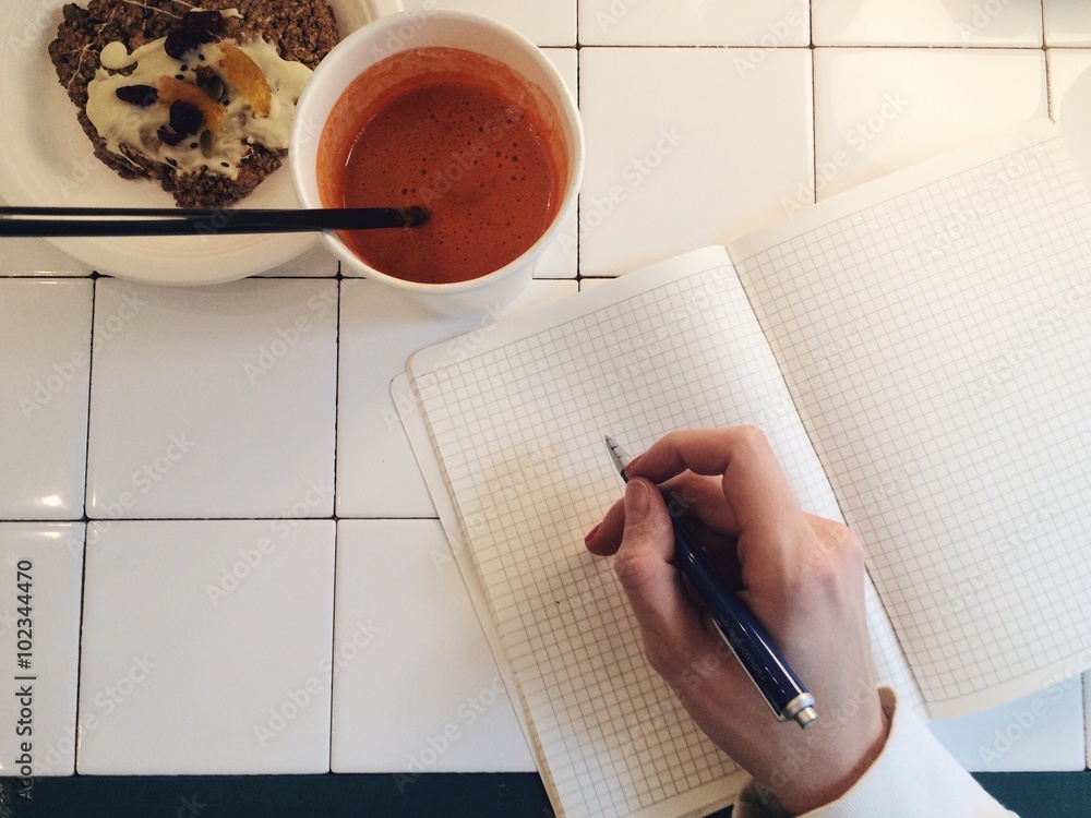 Breakfast in cafe with juice, notebook. Working and writing Stock Photo ...