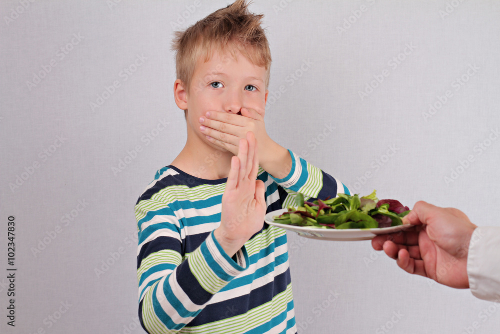 Child refuses to eat salad vegetables Stock Photo | Adobe Stock